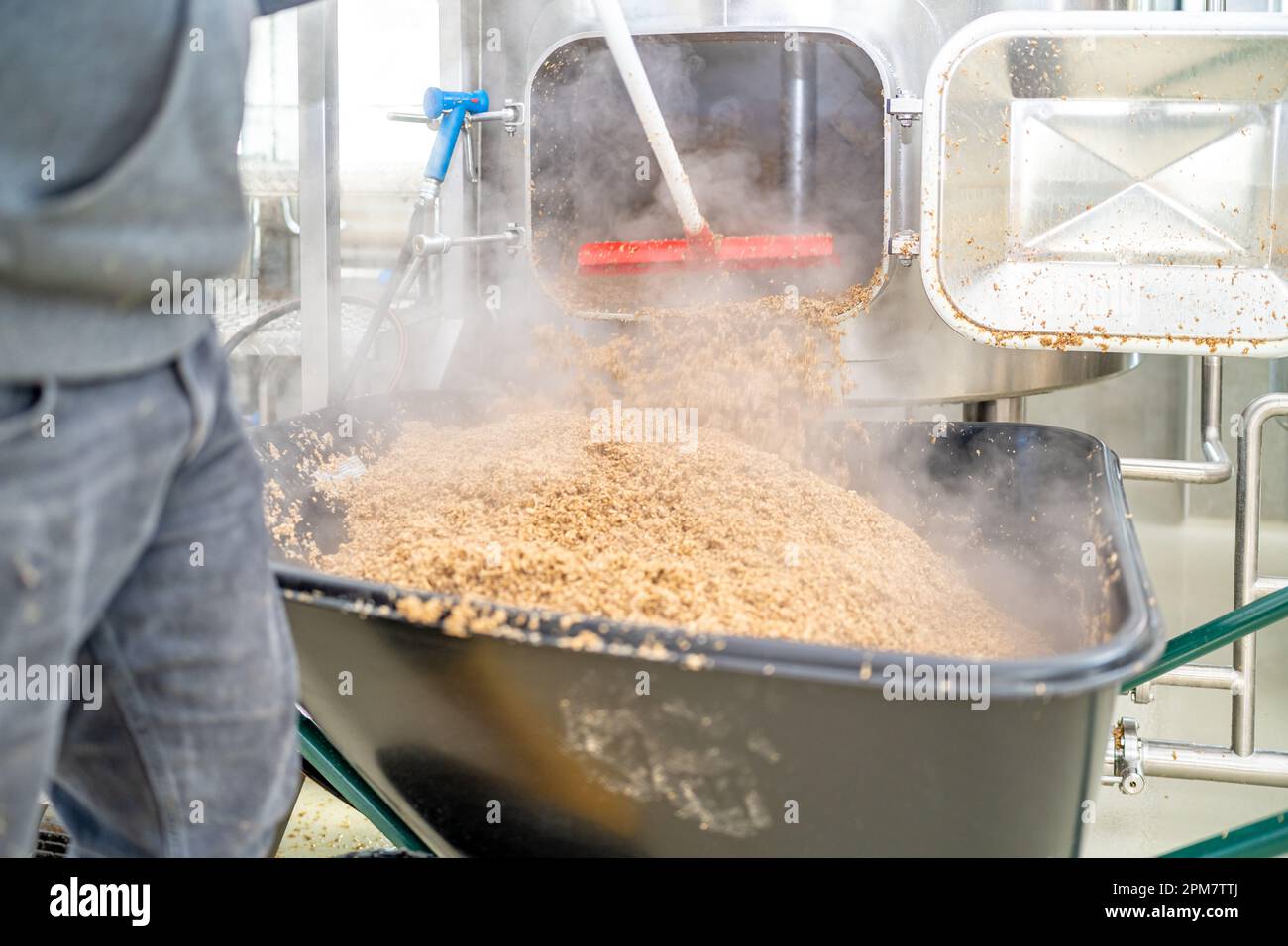 cleaning the boiler from residual malt after brewing beer in the ...