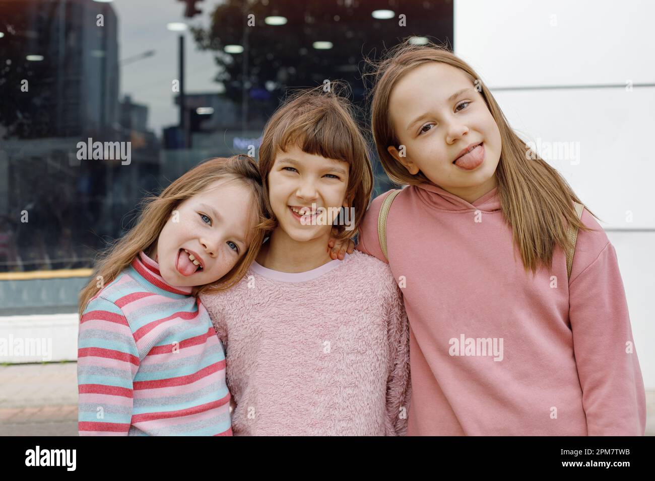Cute happy funny children girls grimacing, portrait. Kids putting out ...
