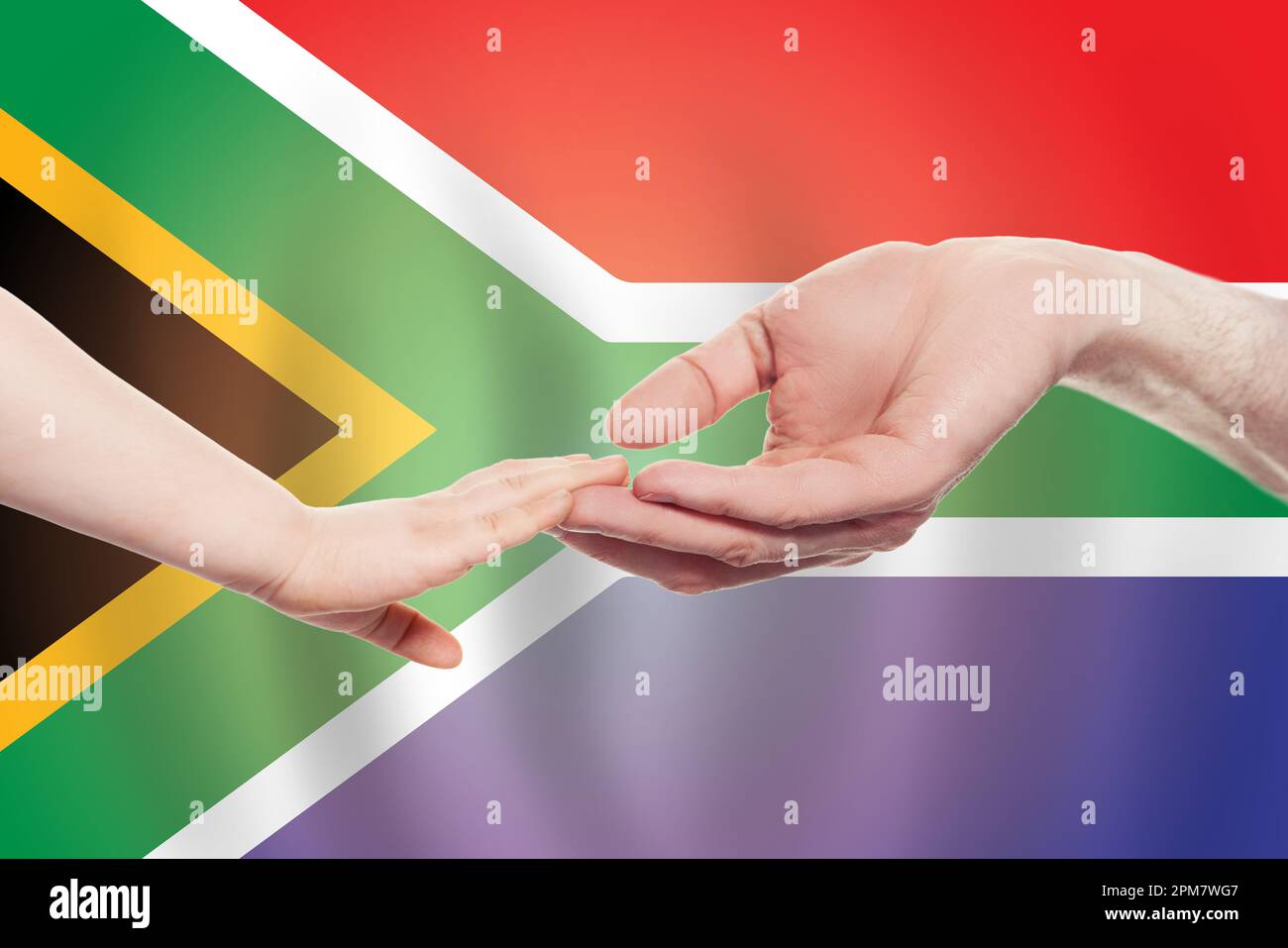 African baby and parent hands on the background of flag of South Africa ...