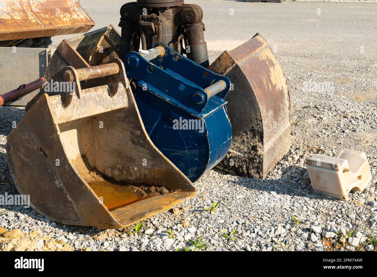 Dirty excavator buckets standing on a construction site. Close up Stock ...