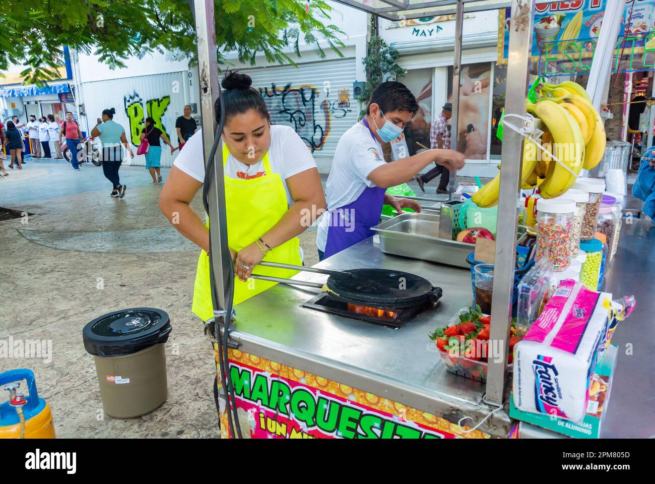 Cancun, Quintana Roo, Mexico, A Mexican woman coking marquesita that is ...