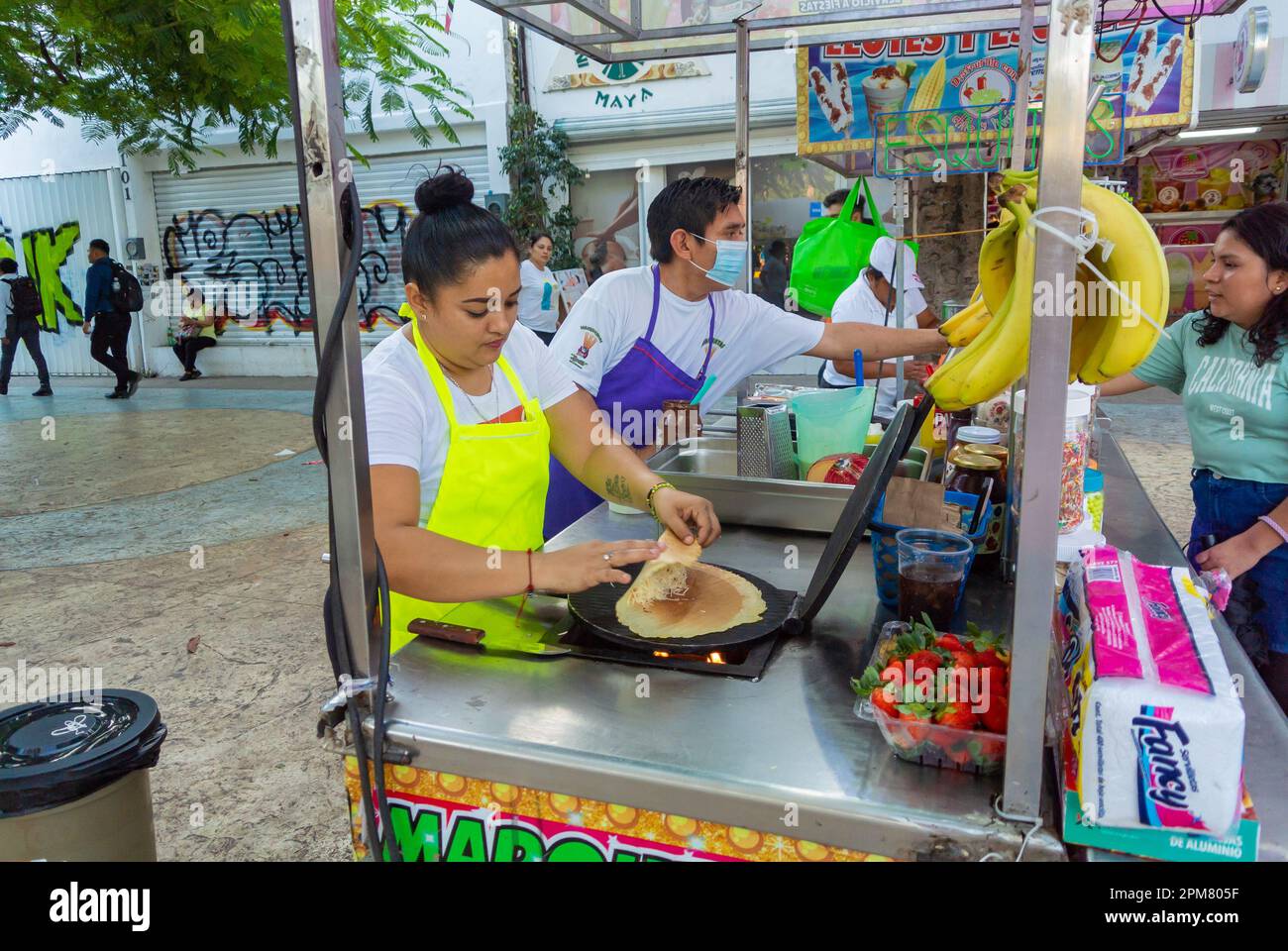 Cancun, Quintana Roo, Mexico, A Mexican woman coking marquesita that is ...