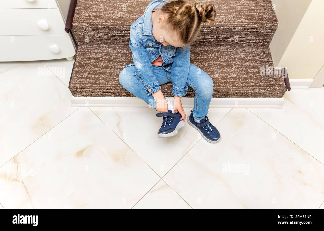 The child does not want to put on shoes Stock Photo - Alamy