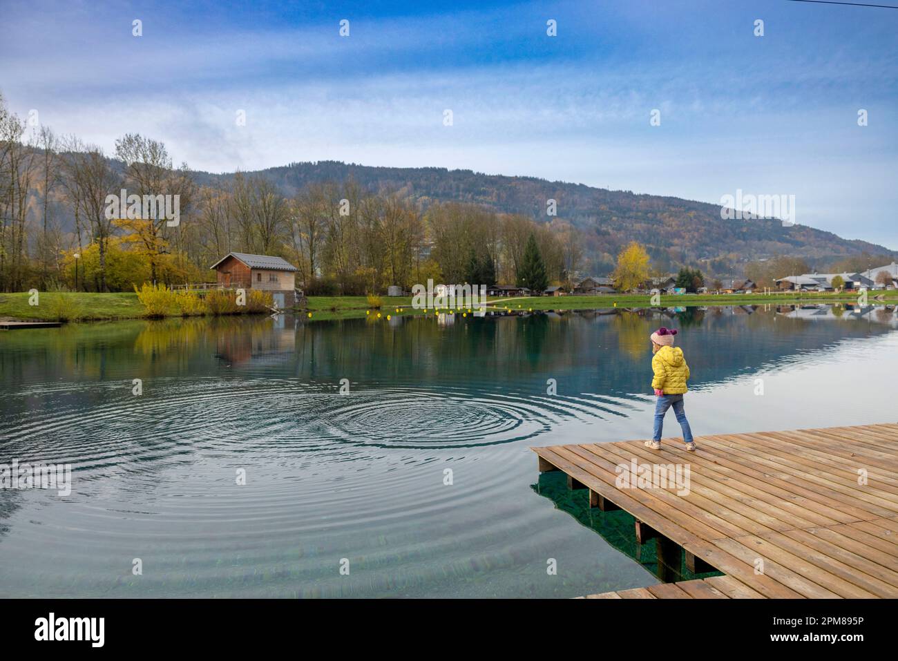 France, Haute-Savoie, Giffre valley, Morillon, a little girl throwing ...