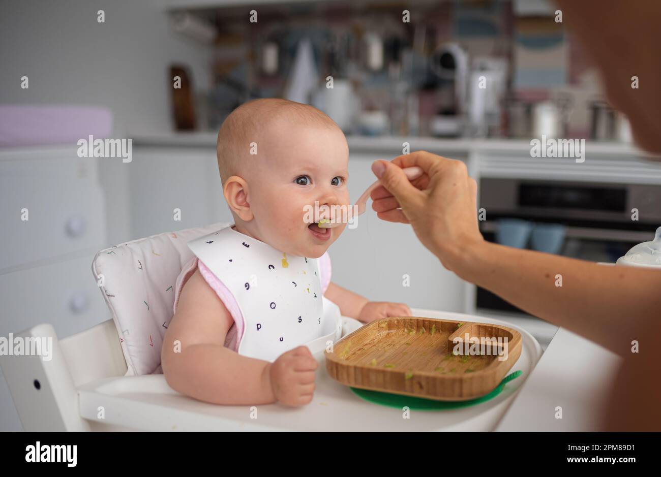 baby's first feeding, mom feeds a baby with a spoon Stock Photo - Alamy