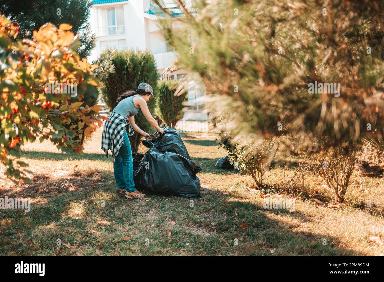 The concept of environmental pollution and Earth day. Woman volunteer ...