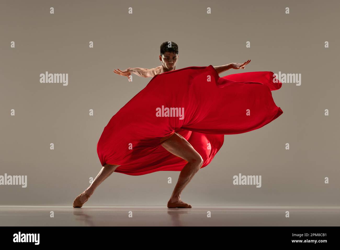 Modern ballet performance. Young, impressive, handsome man dancing with ...