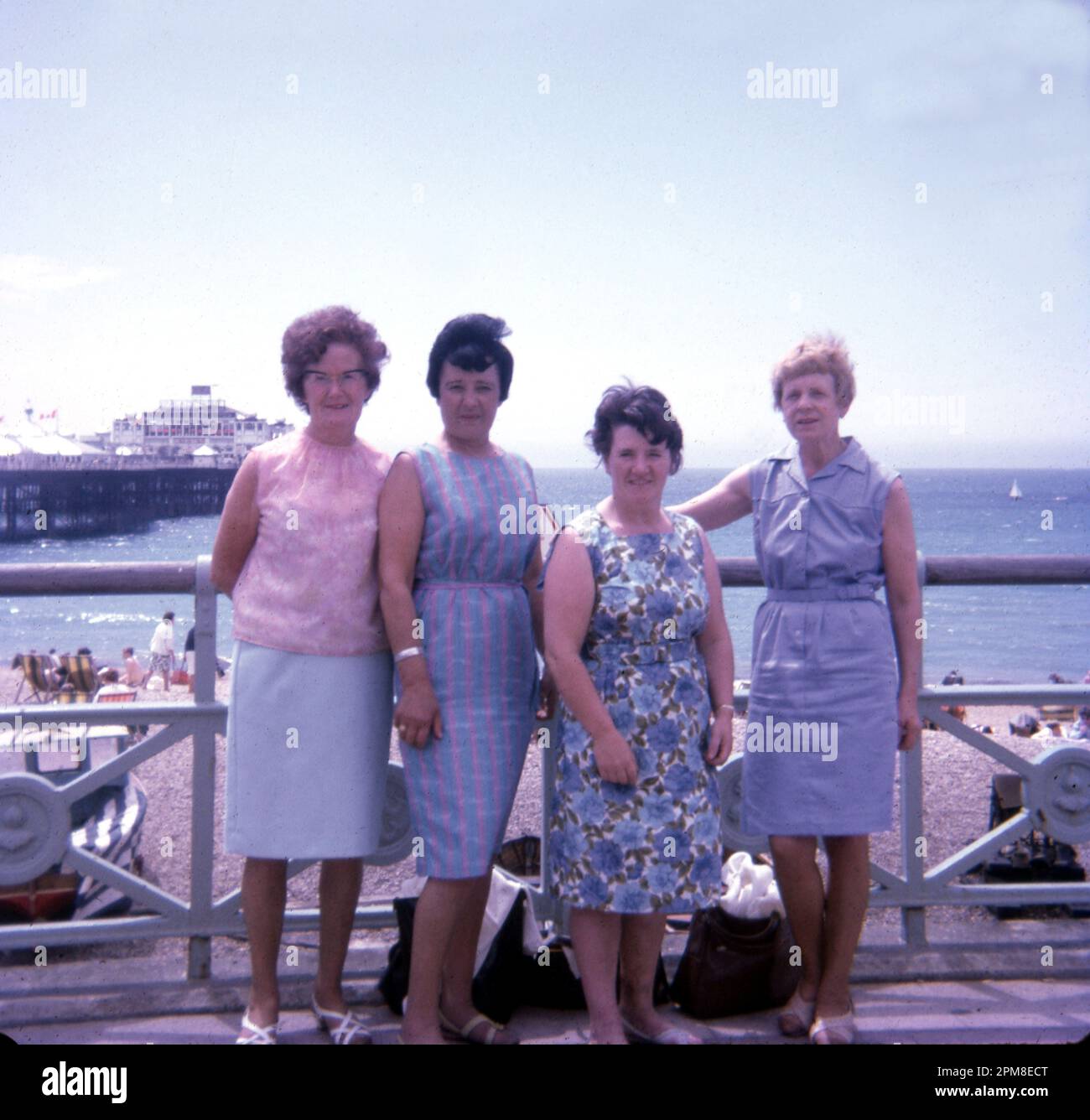 Four women pose on the seafront on a Staff outing at Brighton in ...
