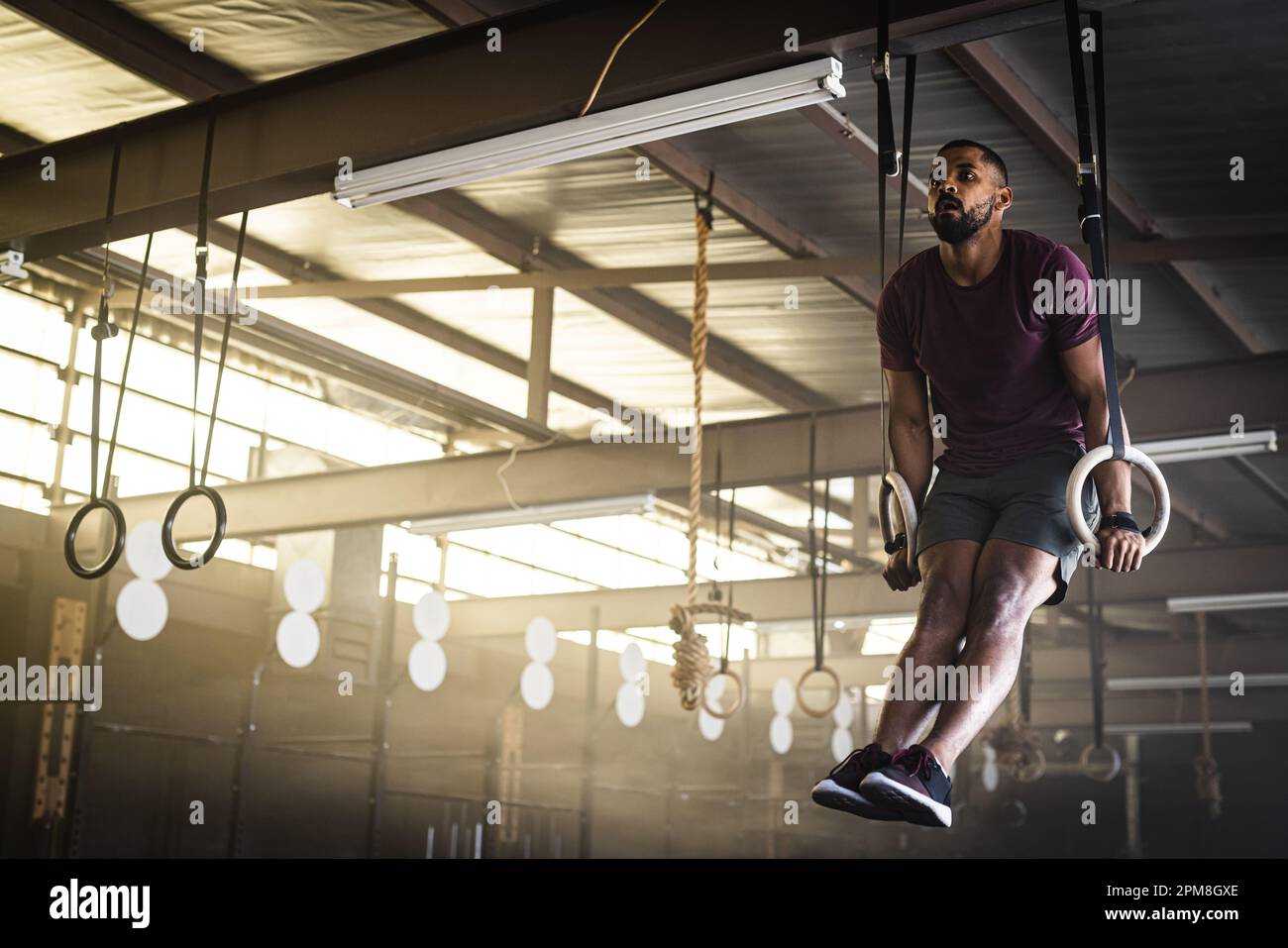Full length of dedicated bearded biracial young man hanging on ...