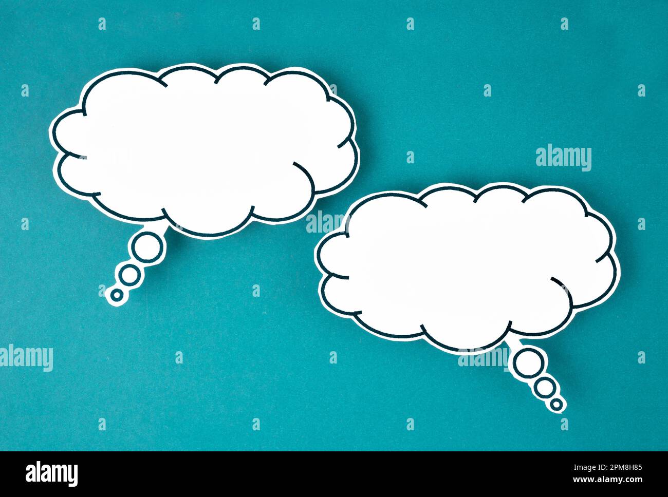 White speech bubble shaped post it note on green background with copy ...