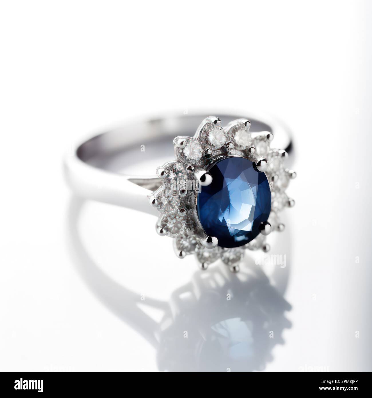 A beautiful sapphire ring with diamonds isolated on a white background ...