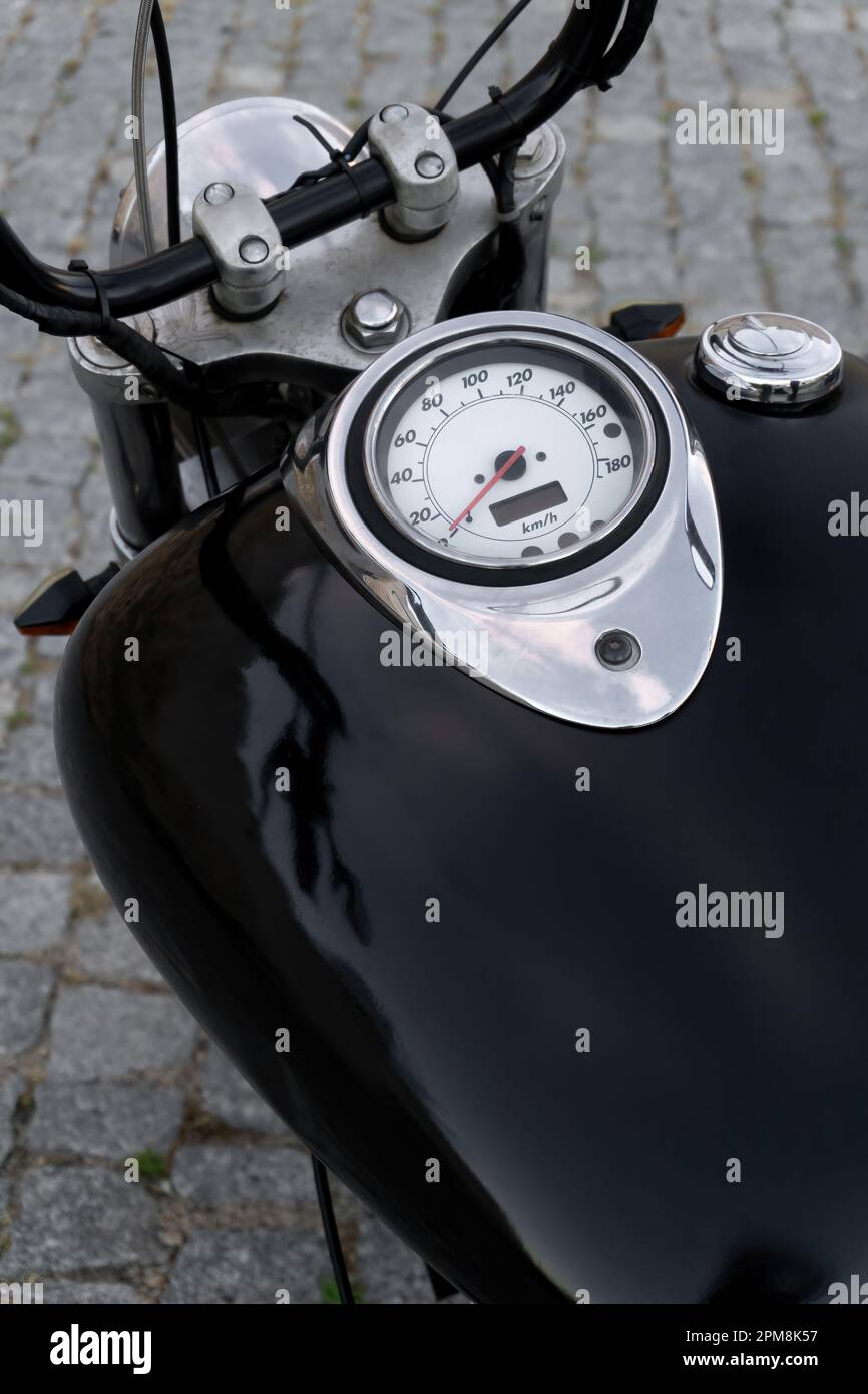 Detail of classic chopper motorcycle black tank with speedometer and ...