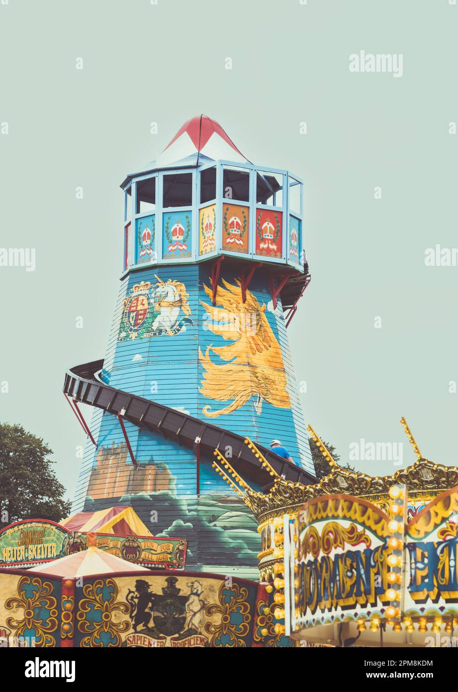 Vintage carousel rides and a helter skelter at a summer carnival Stock ...
