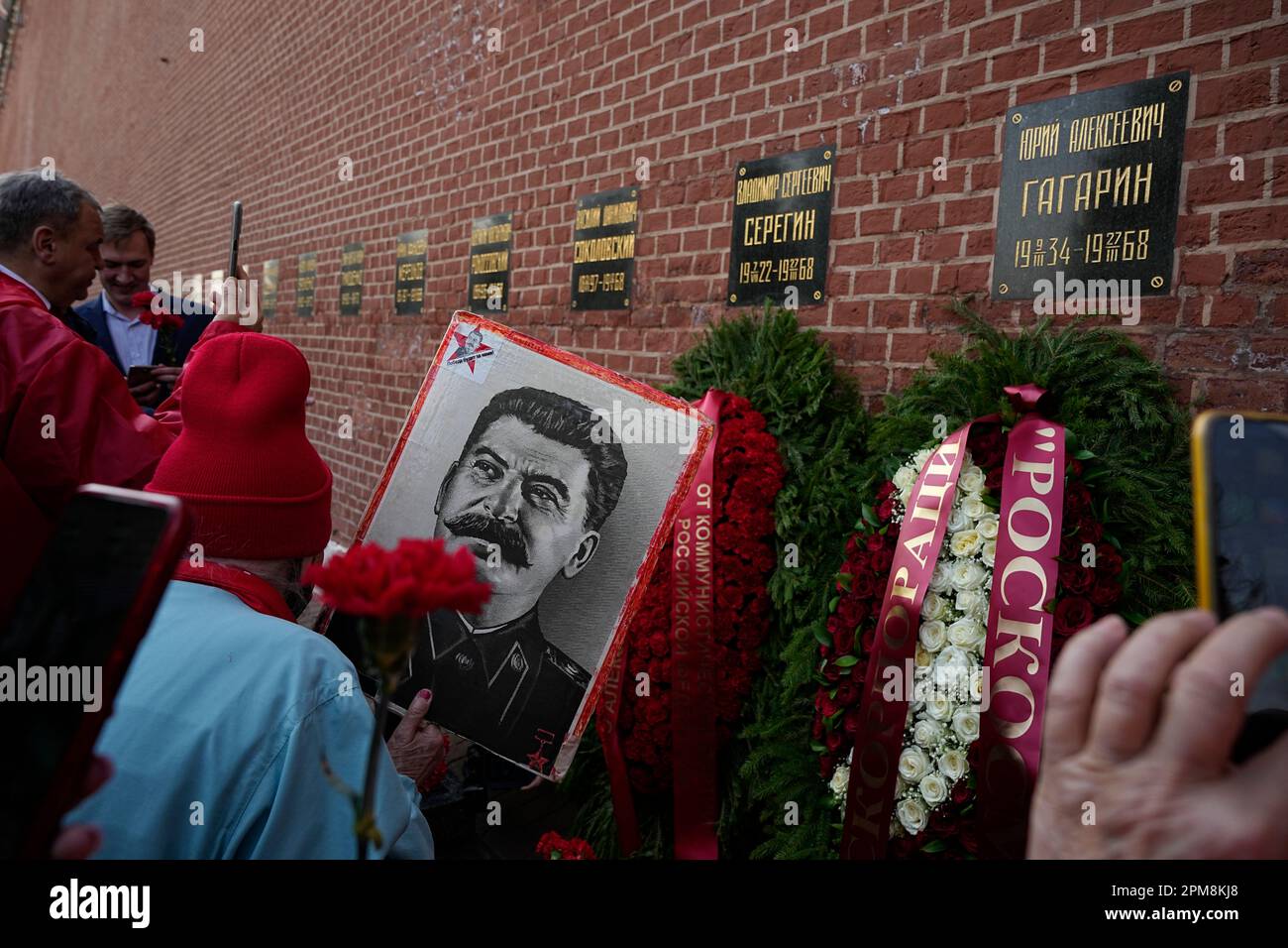 Communist's party supporters, one of them with a portrait of Soviet ...