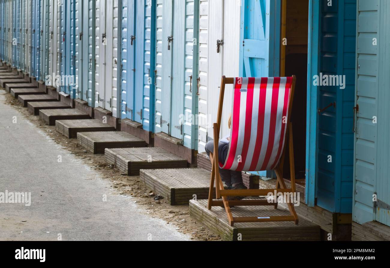 Single Red Striped Deckchair Outside A Line Of Beach Huts, Avon Beach ...