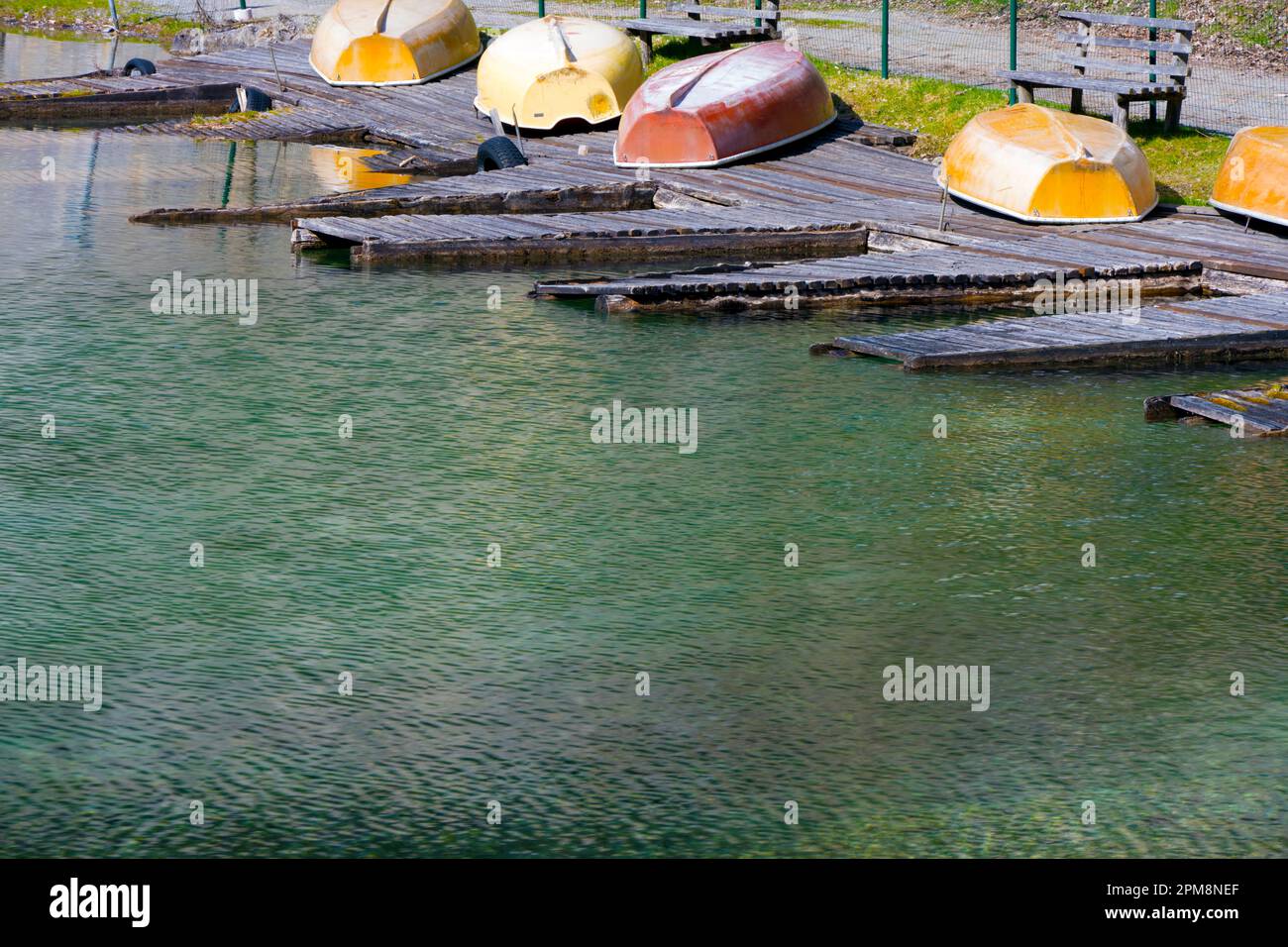 lake with upside down oar boats lying on withered rotten abandoned old ...