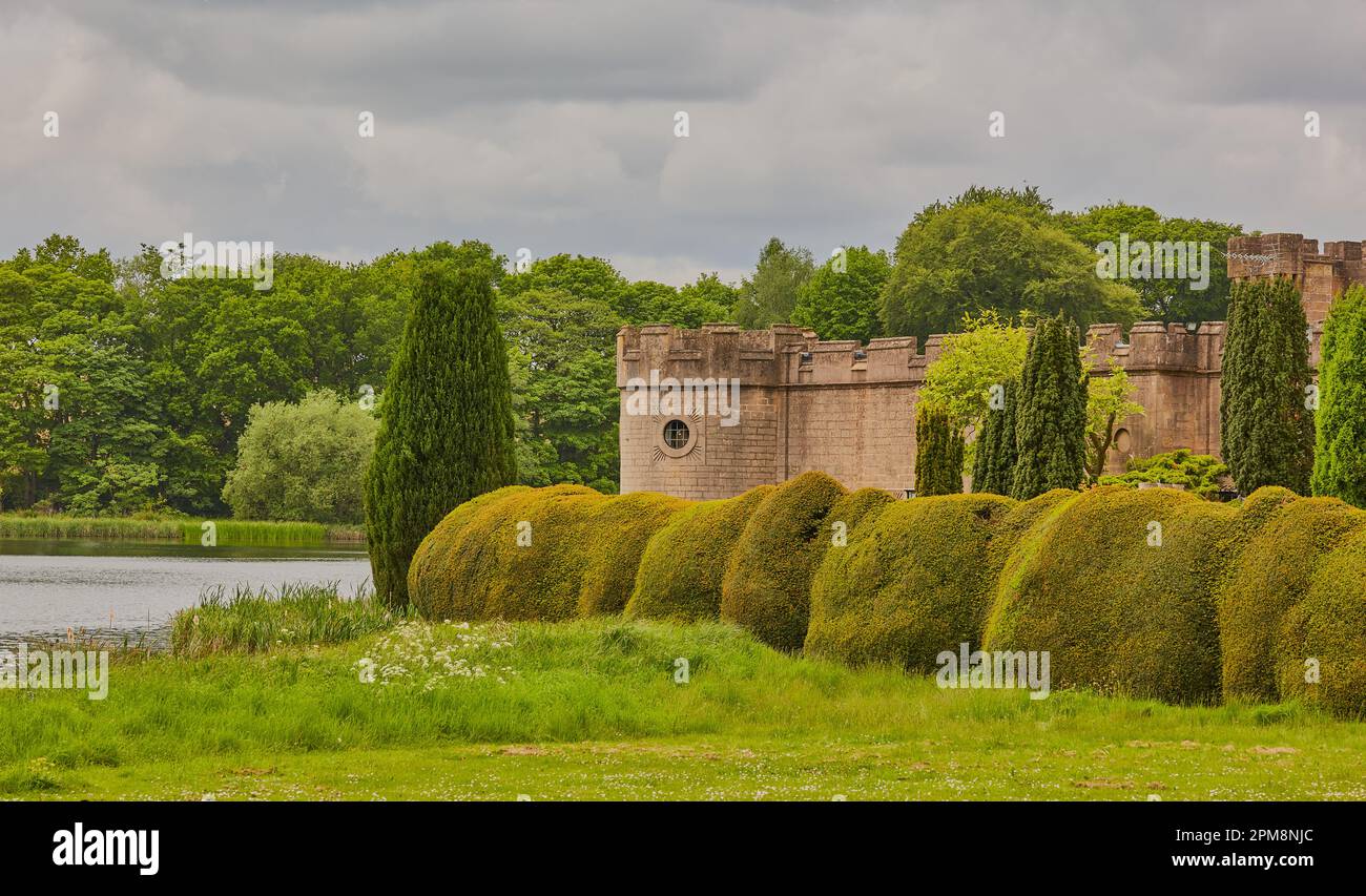 Landscape image with a castle surrounded with woodland and a lake at ...