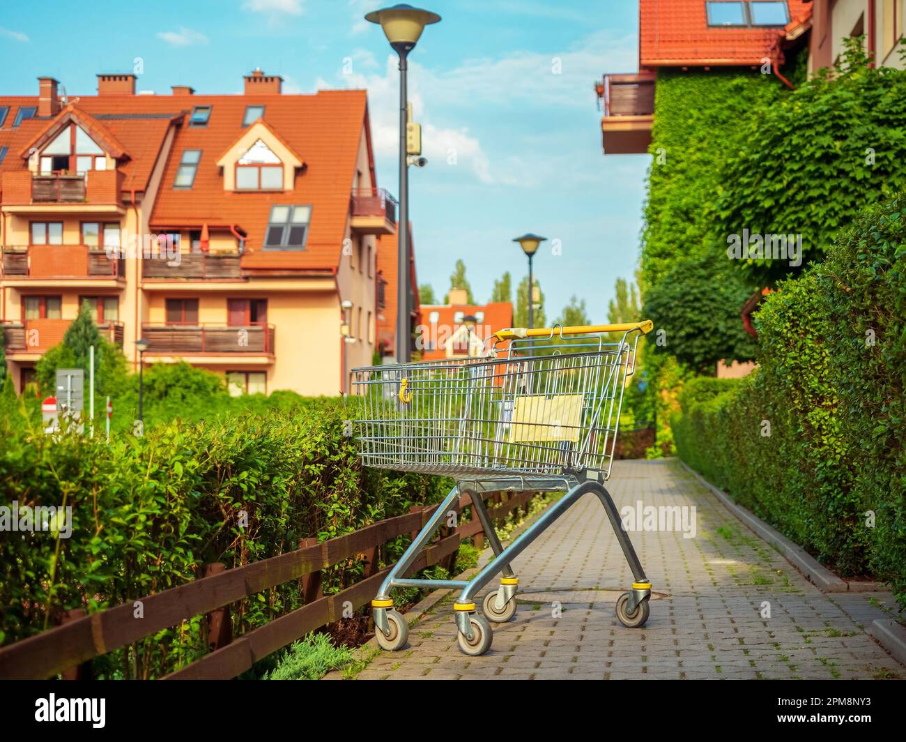 empty trolley shopping cart outside near apartment house entrance ...