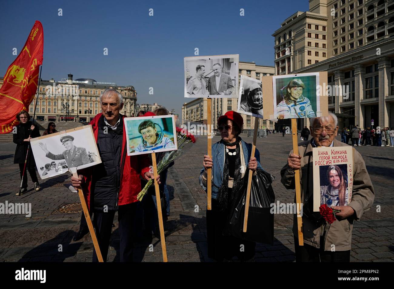 Communist's party supporters stand with portraits of Soviet and Russian ...