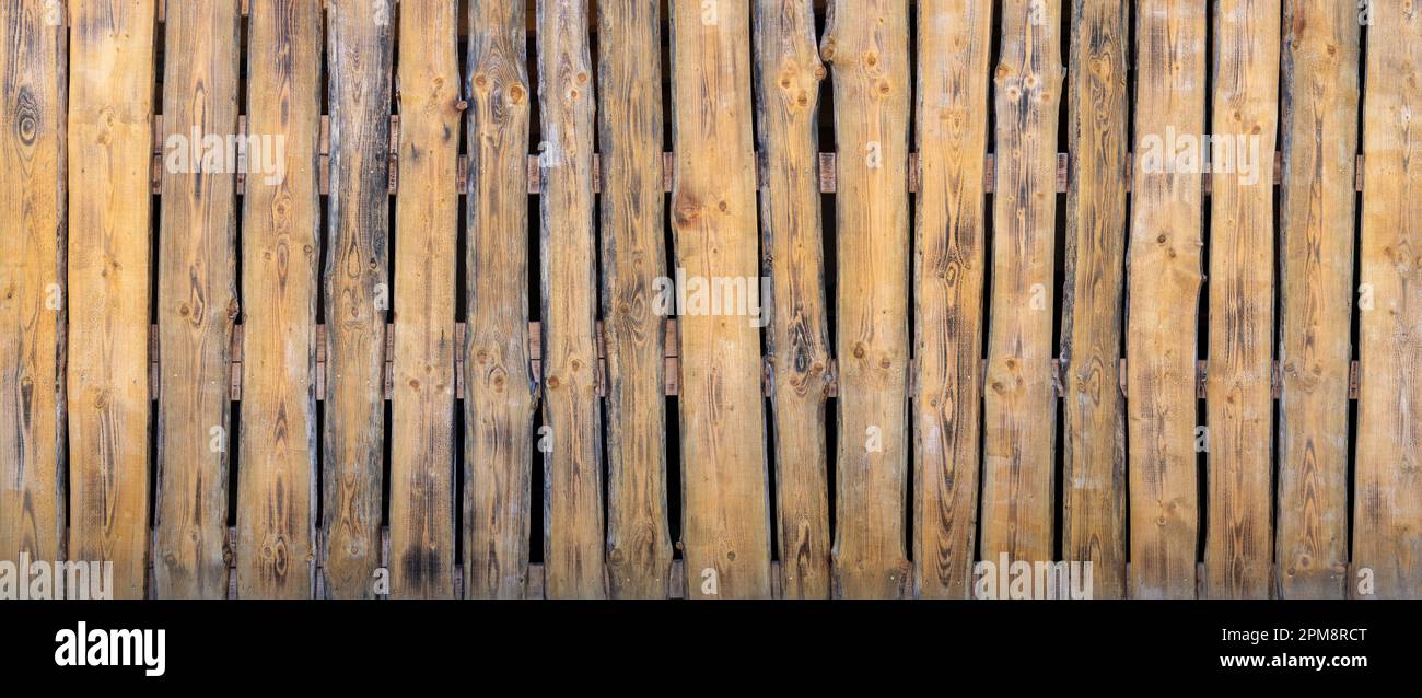 Old yellow-brown plank partition wall against dark background Stock ...