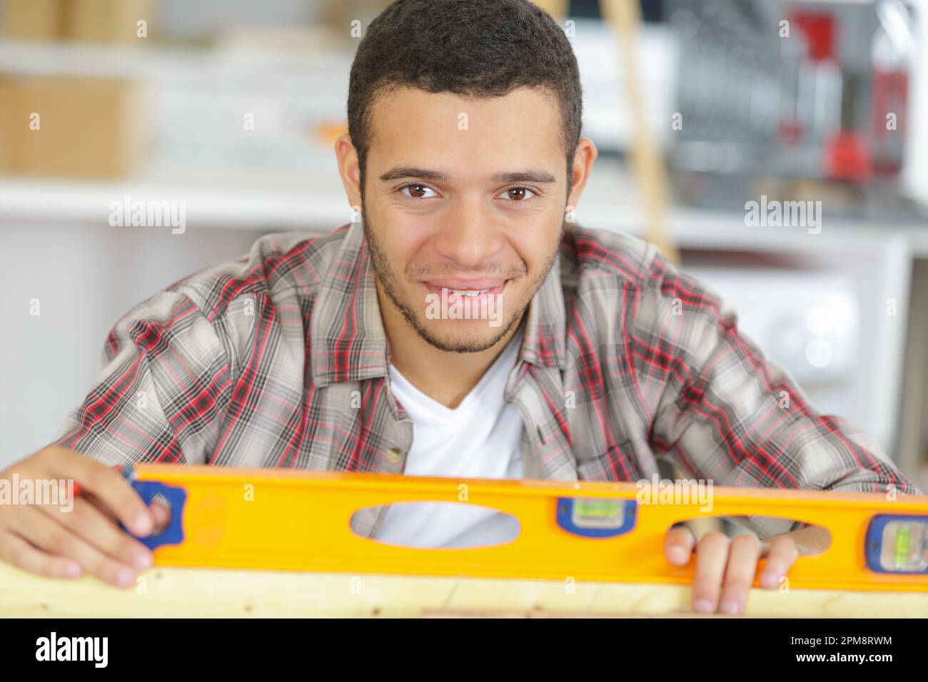carpenter working with a spirit level Stock Photo - Alamy