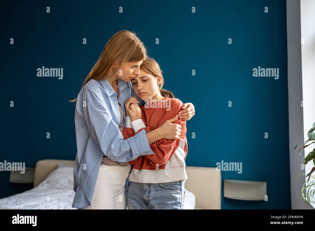 Affectionate empathic young mom tender embracing calming sad upset teen ...