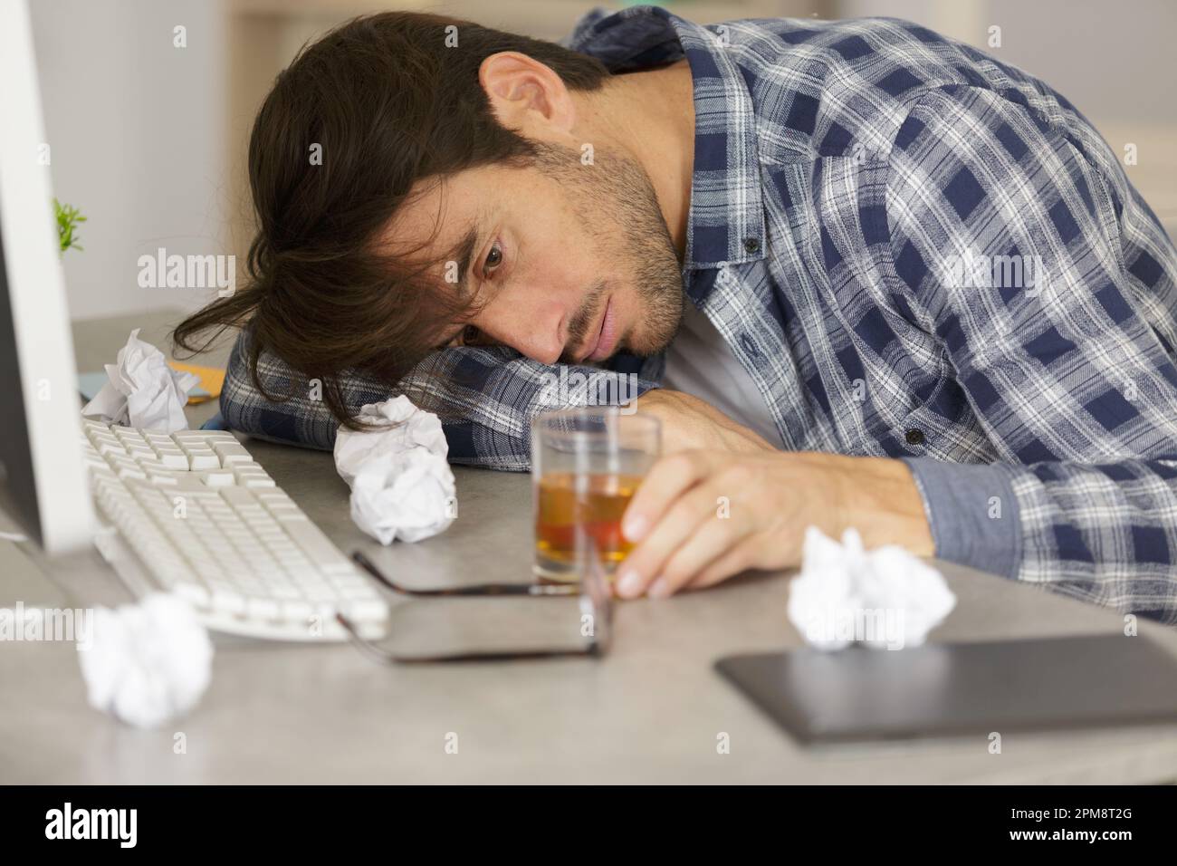 businessman drinking from stress at workplace Stock Photo - Alamy