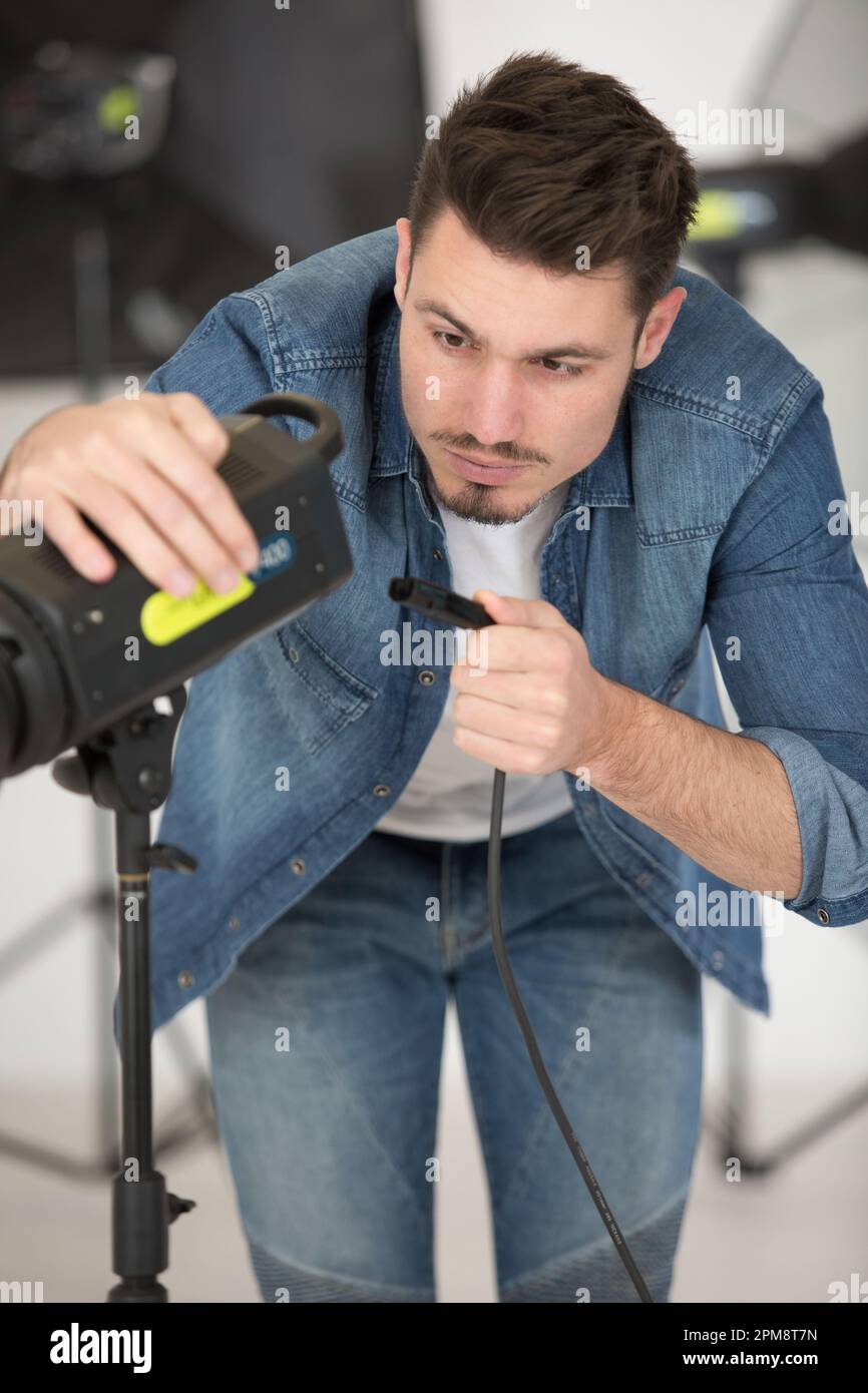 photographer is fixing studio flashes Stock Photo - Alamy