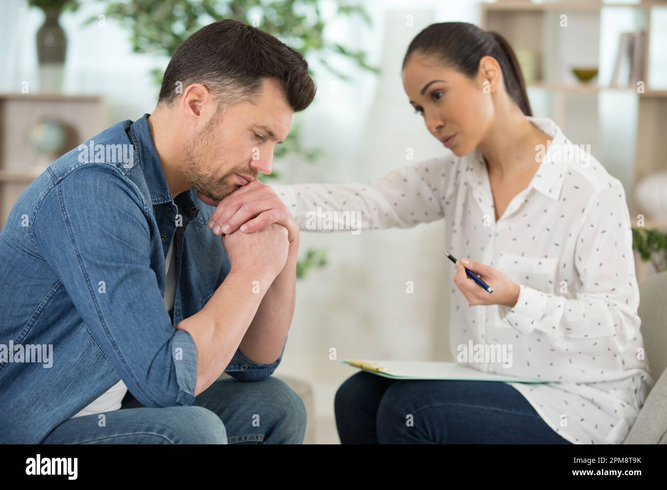 young woman supporting depressed frustrated husband Stock Photo - Alamy