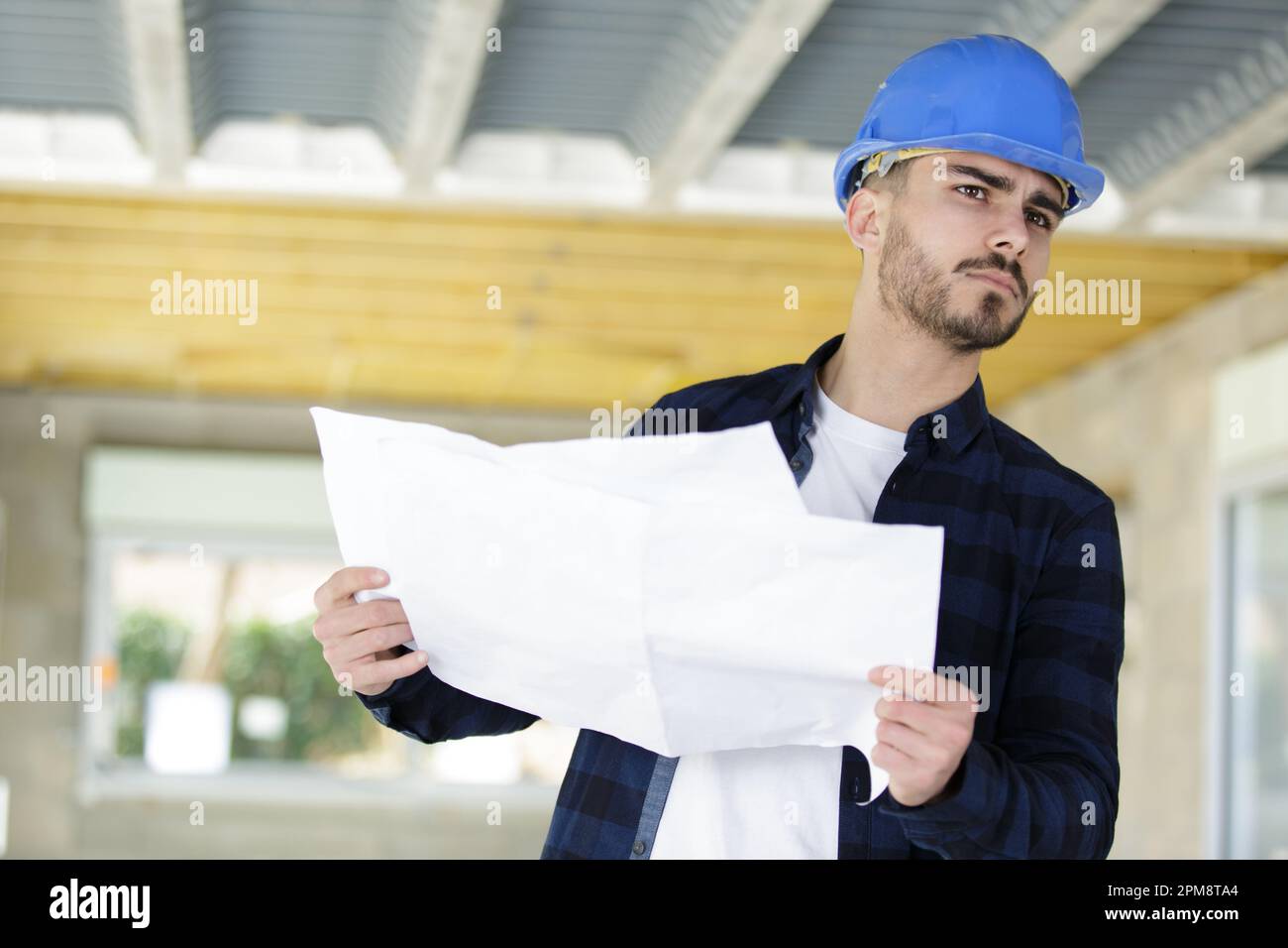 attractive and confident constructor working indoors Stock Photo - Alamy