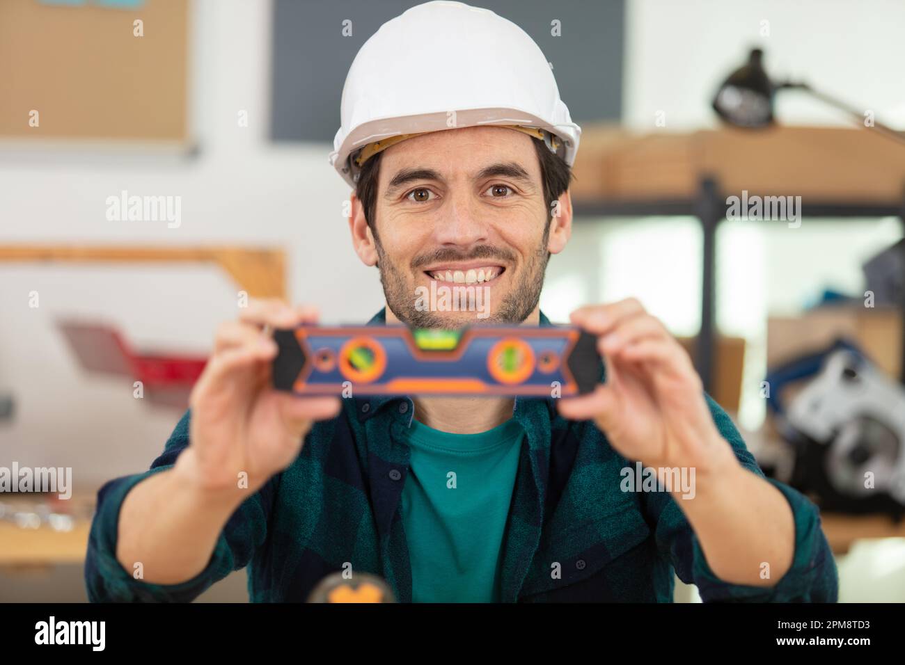 construction worker using spirit level in a new house Stock Photo - Alamy