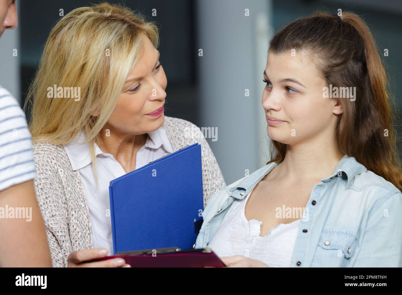 a teacher and student talking Stock Photo - Alamy