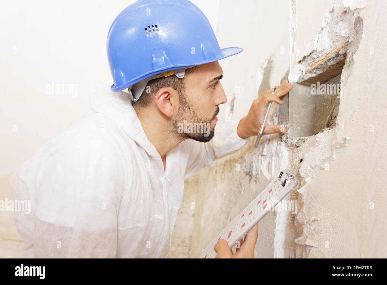 man and wall problem inspection Stock Photo - Alamy