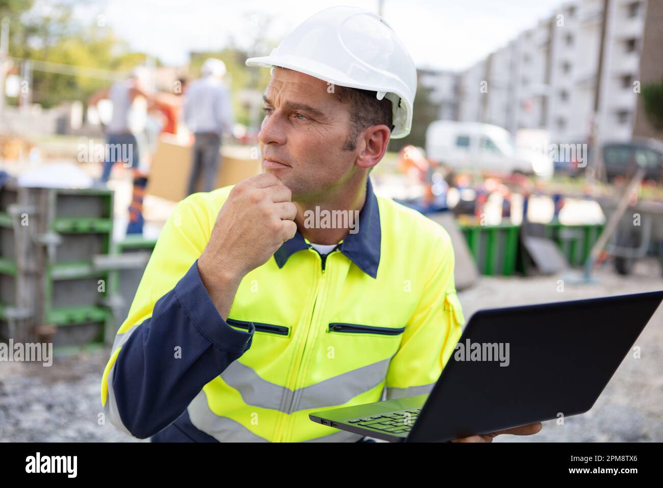 engineer builder with laptop computer at construction site Stock Photo ...