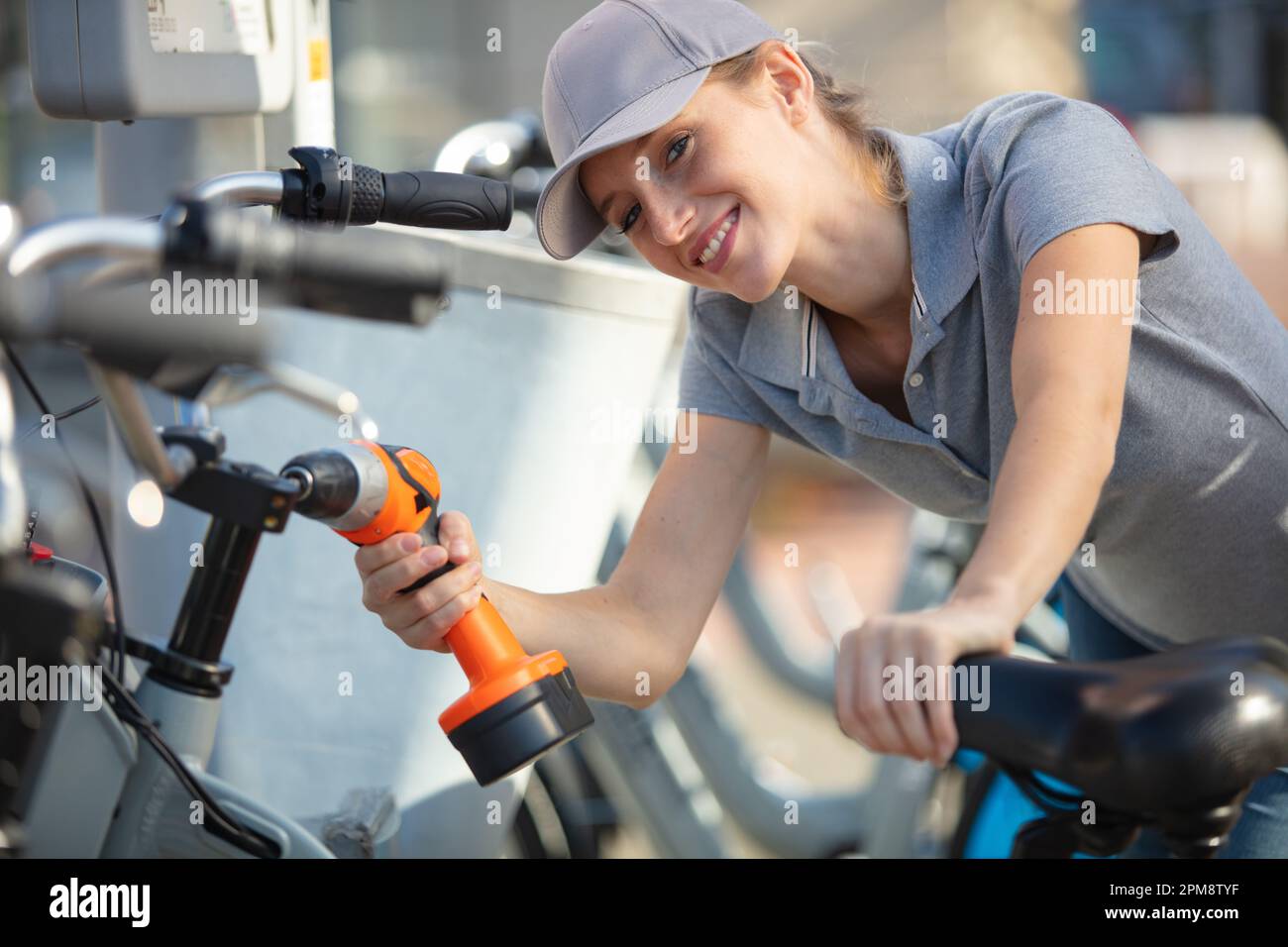 Woman fixing bike using hi-res stock photography and images - Alamy