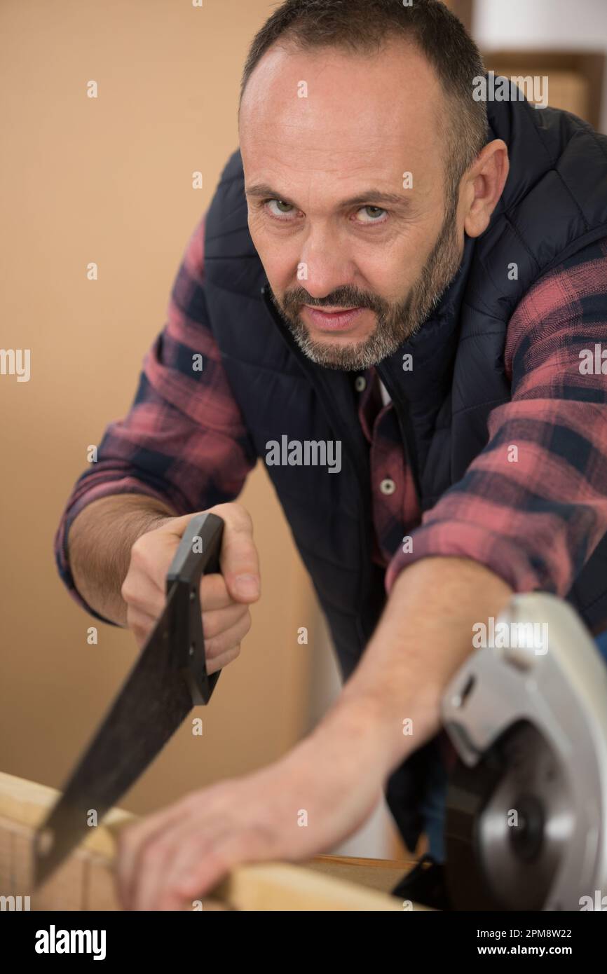 Man using handsaw hi-res stock photography and images - Alamy