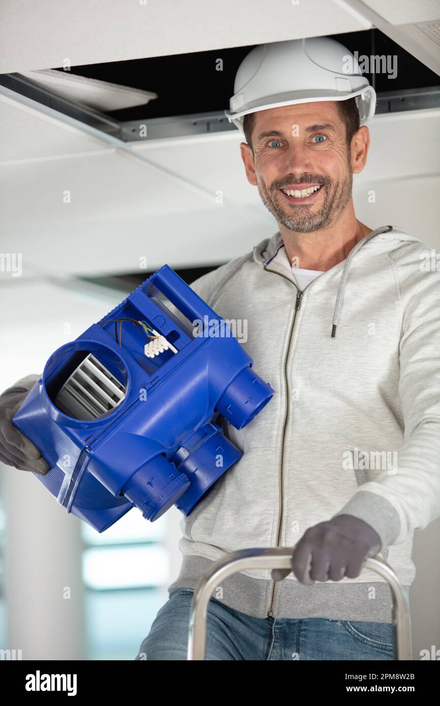 builder replacing electronic device ceiling panel Stock Photo - Alamy