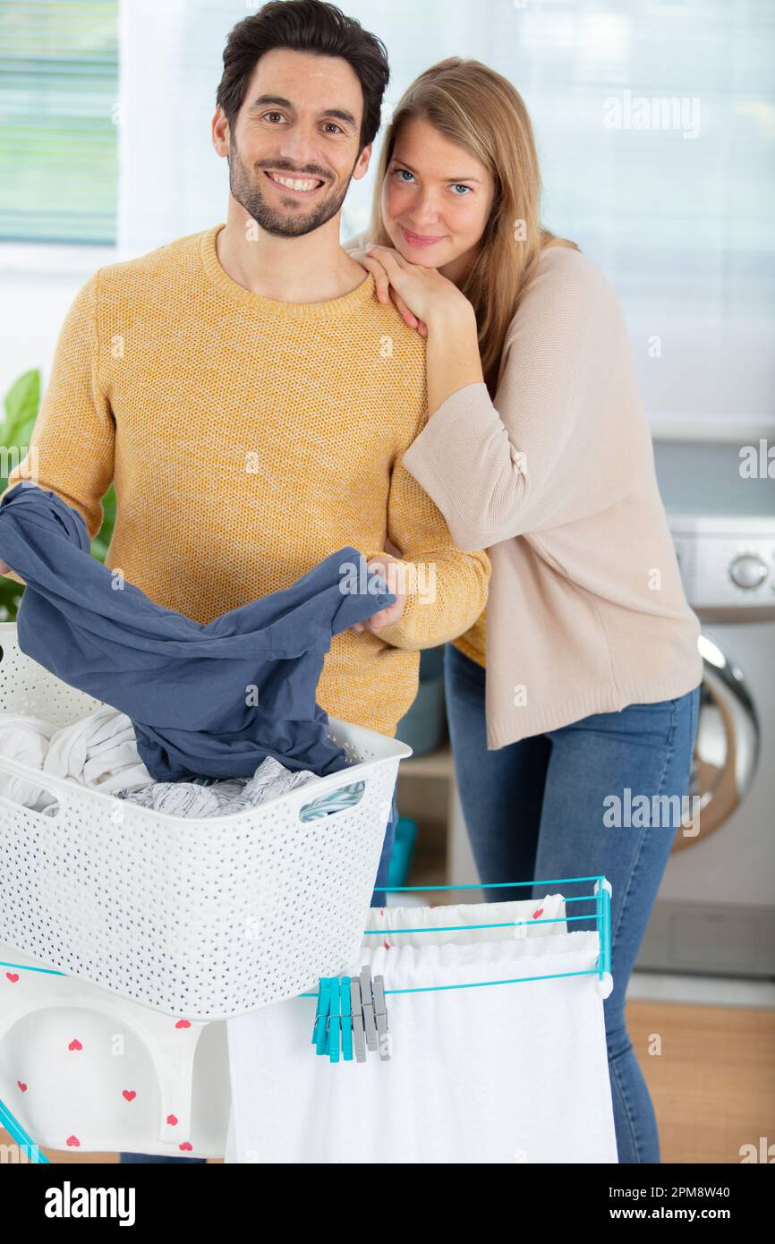 loving couple sorting laundry together Stock Photo - Alamy