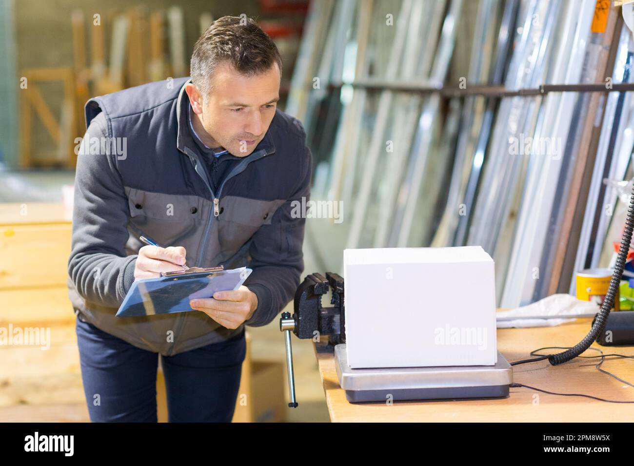 man measuring large machine part in factory Stock Photo - Alamy