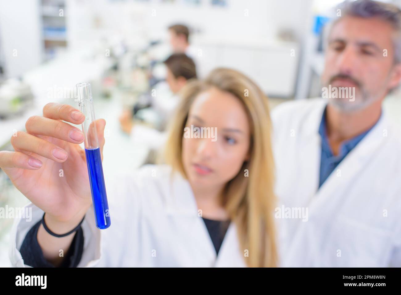 Female scientist holding test tube Stock Photo - Alamy