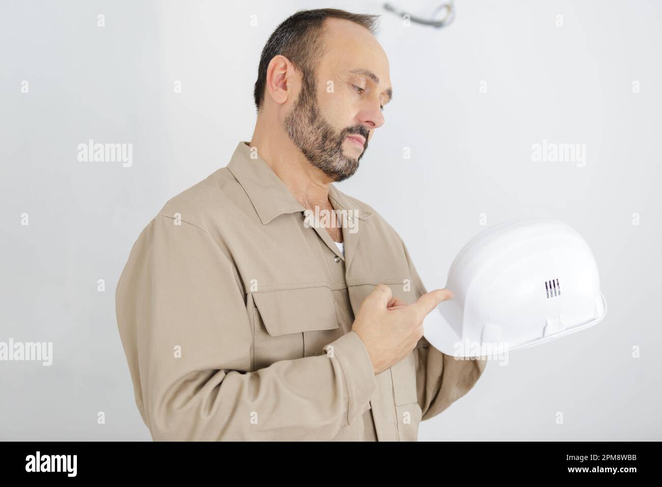 engineer showing with finger his helmet Stock Photo - Alamy