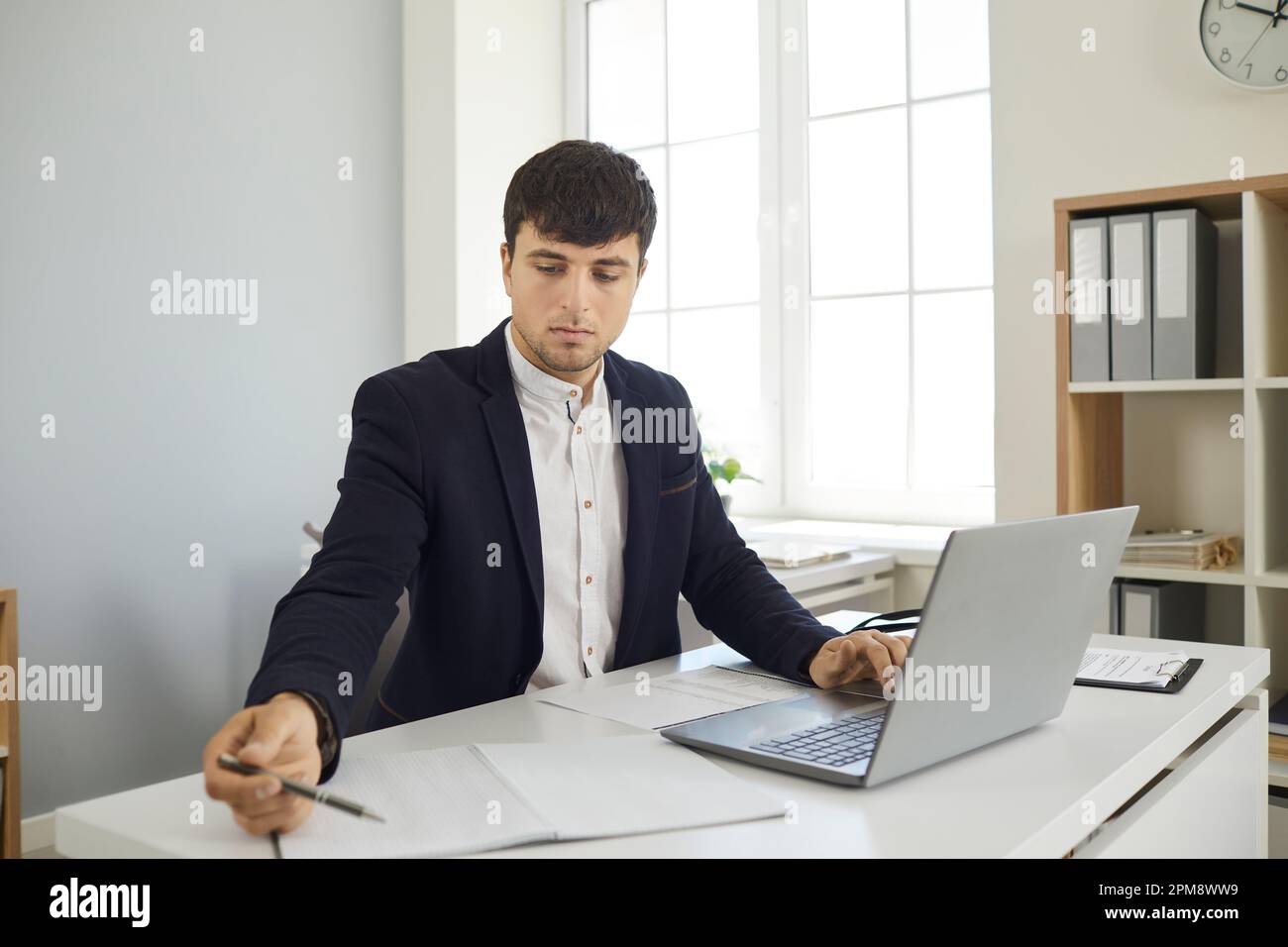 Business man on online meeting with clients writing making notes during ...