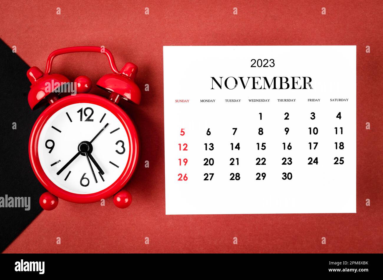 November 2023 Monthly calendar year with alarm clock on red and black ...