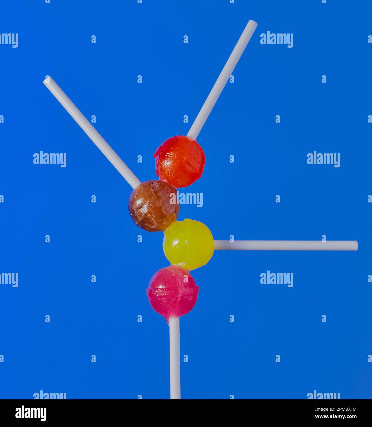 Group of different flavoured and coloured lollipops on a blue ...