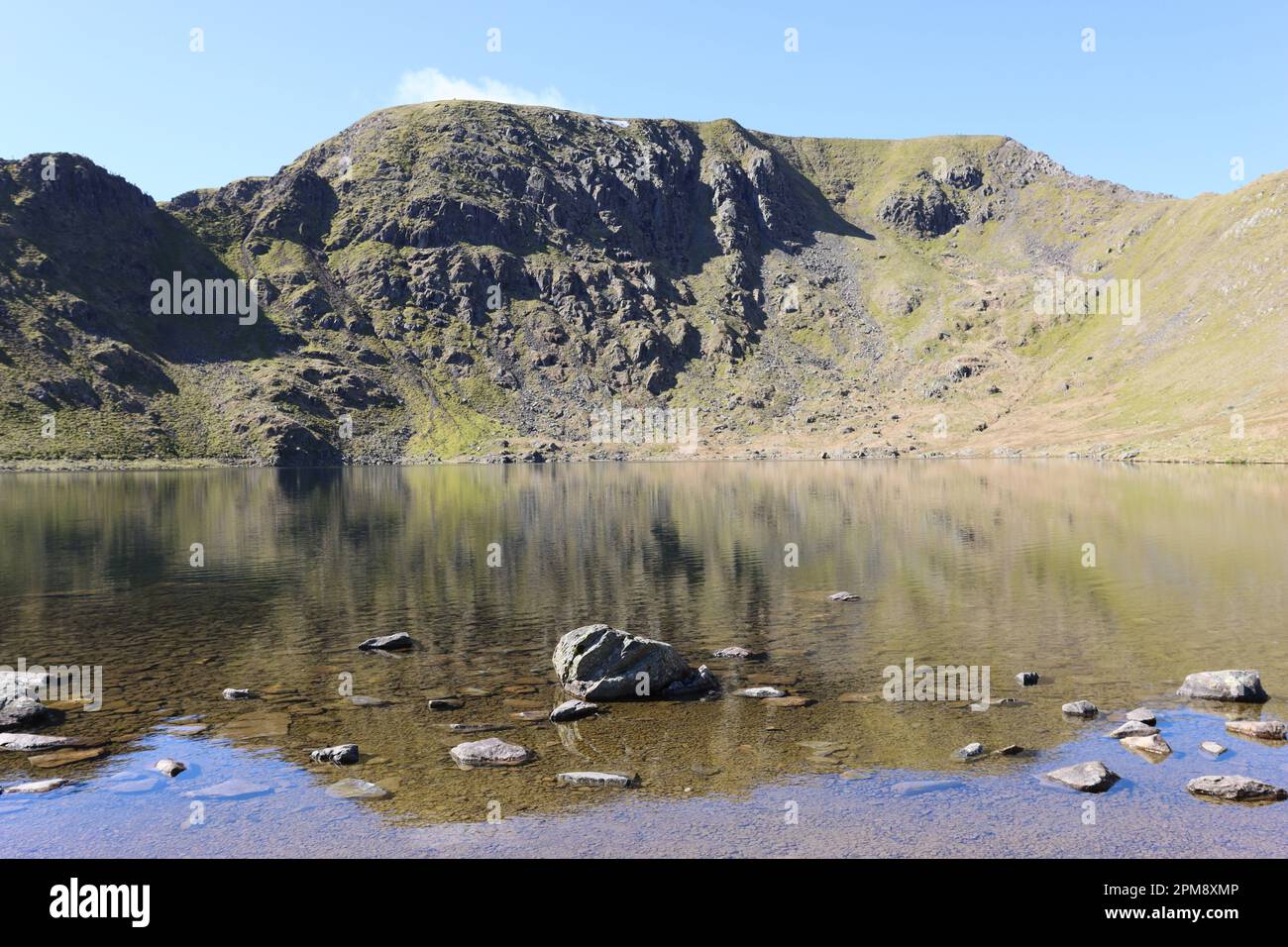 View of Helvellyn from Red Tarn on a sunny day with the mountain ...