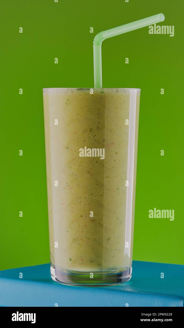 Healthy smoothie drink with a straw on a green background Stock Photo ...