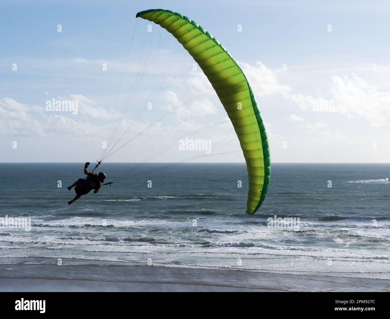 Paraglider soaring above ocean in hi-res stock photography and images ...