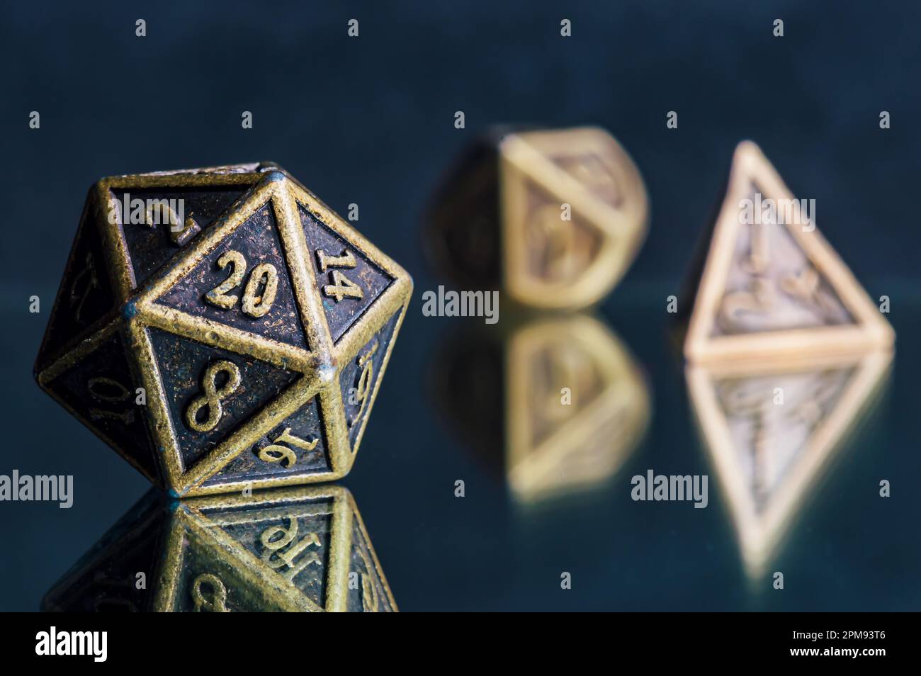 Close-up image of a metallic 20-sided Role-Playing dice on a reflective ...
