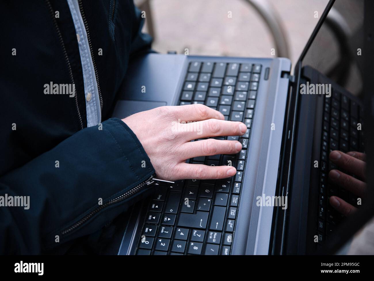 Men's hand typing on a laptop keyboard. Selective focus Stock Photo - Alamy