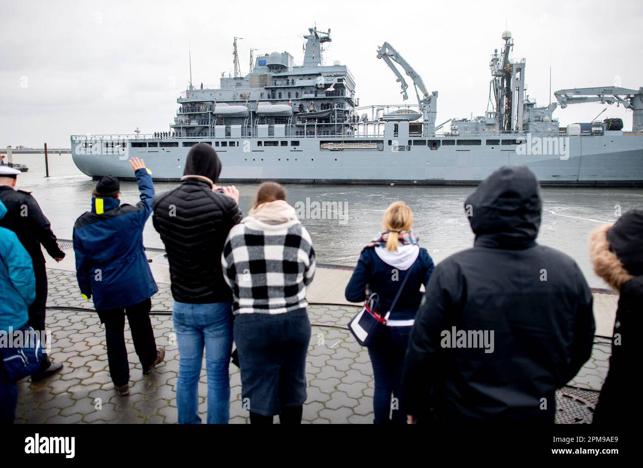 Wilhelmshaven, Germany. 12th Apr, 2023. Members of the crew stand on a ...